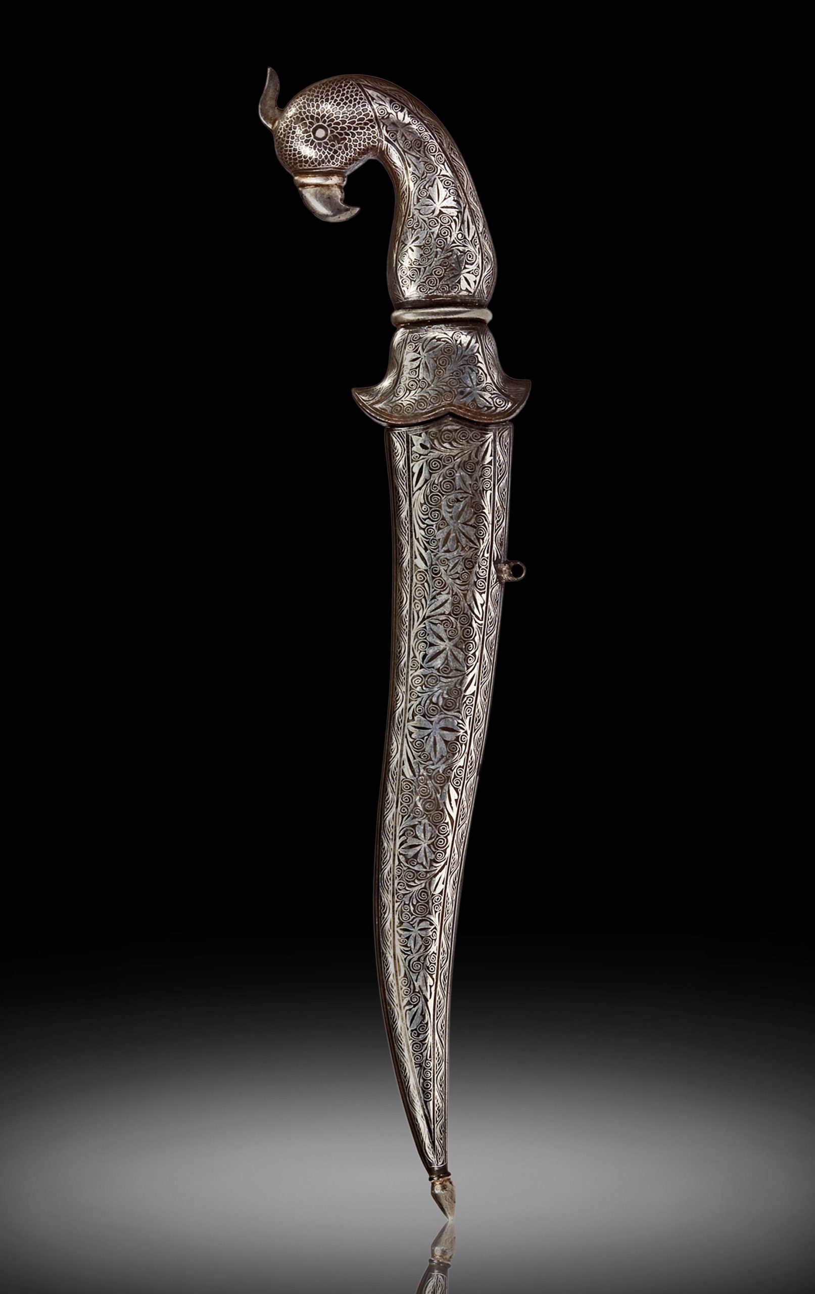 A SILVER-OVERLAID IRON KOFTGARI PARROT'S HEAD-HILTED DAGGER AND ...